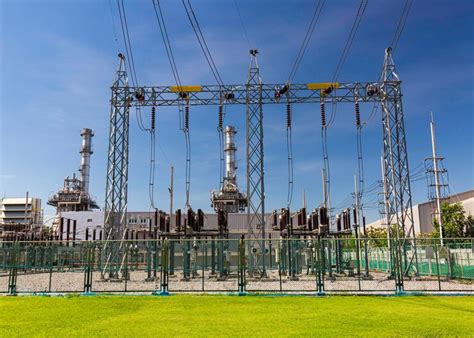 Premium Photo Column High Voltage Transformer Against The Field Green Electric Current