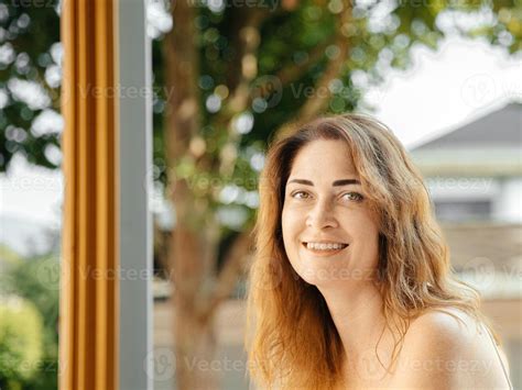 Smiling Woman Relaxing Indoors Near Window With Nature View 52645236