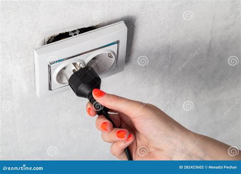 The Girl Puts The Electric Plug Into A Broken Socket Risk Of Electric Shock Close Up Stock
