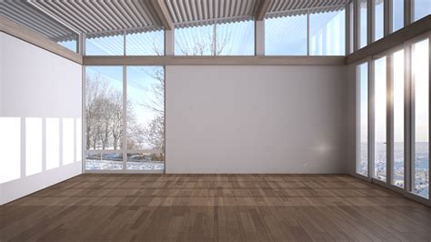 빈 방 인테리어 디자인 눈이있는 겨울 전망의 큰 파노라마 창문이있는 열린 공간 쪽모이 세공 나무 바닥 골판지 지붕 현대적인 최소한의 건축 아이디어 복사 공간 겨울에 대한