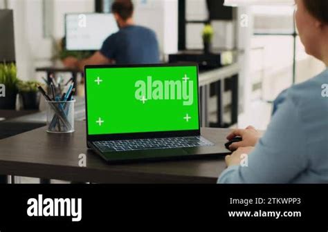 Company Specialist Using Laptop With Greenscreen Template Working With Mockup Chromakey Display
