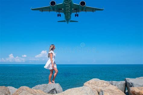 Coastal Encounter Girl In White Dress On Stones Plane Beckoning From