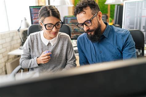 Software Programmers Analyzing Html Code And Database Brainstorming