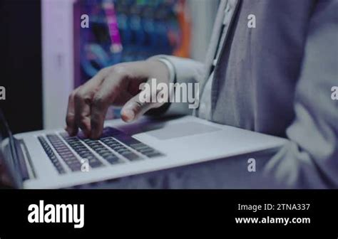 Close Up Shot Of Hands Of African American It Engineer Typing On Laptop In Server Room While