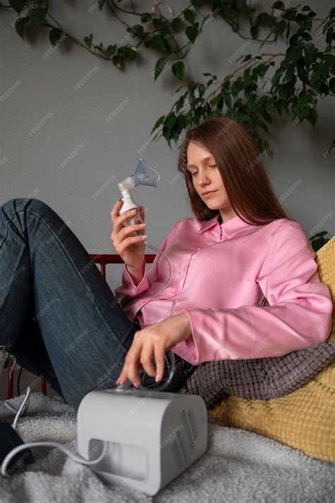 Free Photo Side View Woman Using Nebulizer At Home