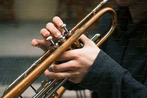 A Close Up Of A Person Playing A Trumpet Photo Brass Image On Unsplash