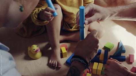 Girl Building Tower From Blocks With Parents By Stocksy Contributor Milles Team Stocksy