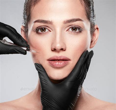 Caucasian Woman Getting Botox Cosmetic Injection In Forehead Woman Gets Botox Injection In Her