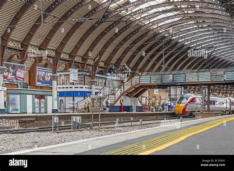 A Railway Station Concourse Under A 19th Century Iron Canopy A