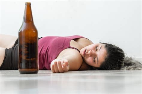 Premium Photo Drunk Woman Lying On The Floor Passed Out Near A Bottle
