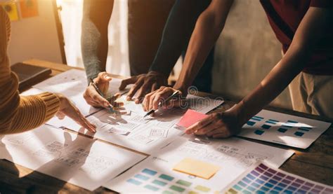 Close Up View Of Ui Developer Team Brainstorming On Their Project With Laptop Smartphone And
