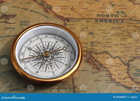 Classic Round Compass On Background Of Old Vintage Map Of World Stock