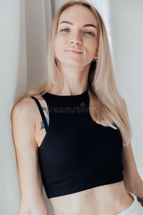 Portrait Of A Beautiful Woman In A Black Swimsuit On The Beach By The