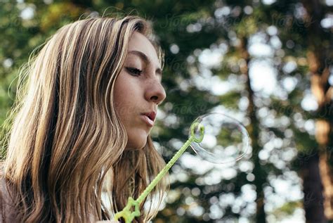 Beautiful Teenage Girl Blowing Bubbles By Stocksy Contributor