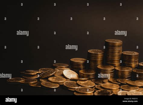 savings increasing columns of coins piles of coins arranged as a graph in dark room business