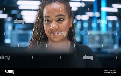 portrait of multiracial female it developer working on desktop in data