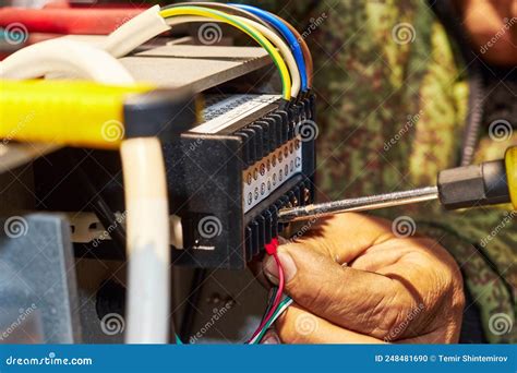 Worker Assembling Contact Panel With Wired Electrical Contactor Stock