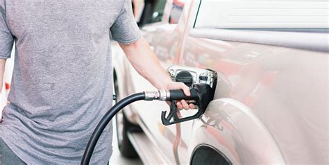 흰색 백인 자동차 소유자는 검은 연료 노즐을 들고 주유소에서 자동차 탱크에 높은 에너지 전력 연료를 채우고 벤진 디젤 Gasohol 가솔린에 대한 상업 서비스 가솔린에 대한