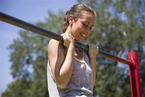 Young Brunette Woman Doing Pull Up On A Sports Horizontal Bar A Stock