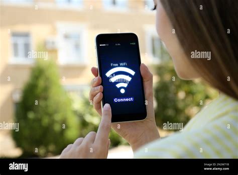 Woman Connecting To WiFi Using Mobile Phone Closeup Stock Photo Alamy