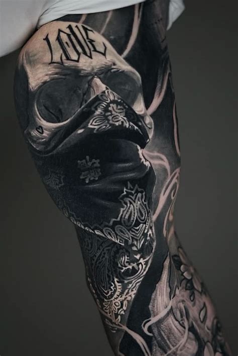 A Mans Leg With Tattoos On It And The Word Love Written In Black Ink