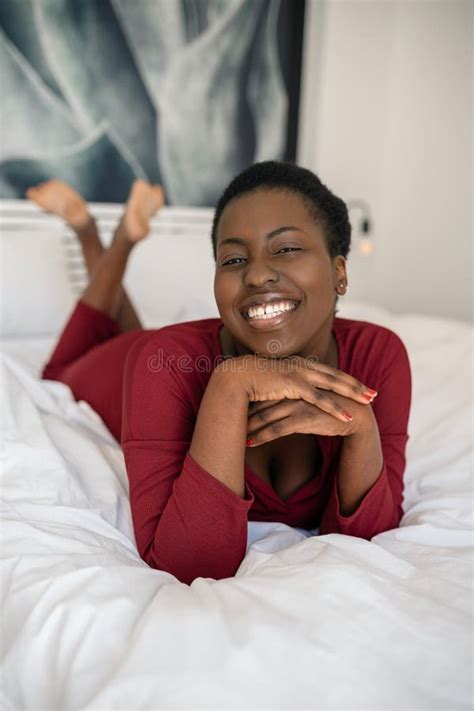 Portrait Black African Woman Laying On Bed Smiling Looking Into Camera
