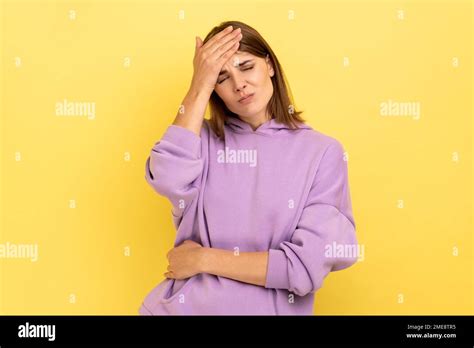 Sad Woman With Dark Hair Making Facepalm Gesture Keeping Hand On Head