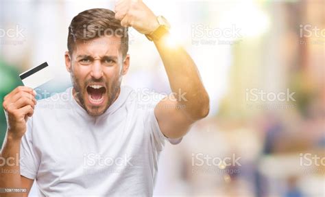 잘생긴 젊은 남자 화가 격리 된 배경 위에 지주 신용 카드 및 미친과 제기 손으로 소리 분노와 좌절 외치고 분노 개념 감정에 대한 스톡 사진 및 기타 이미지 Istock