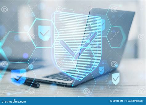 Close Up Of Laptop Computer At Desk With Glowing Hexagonal Shield