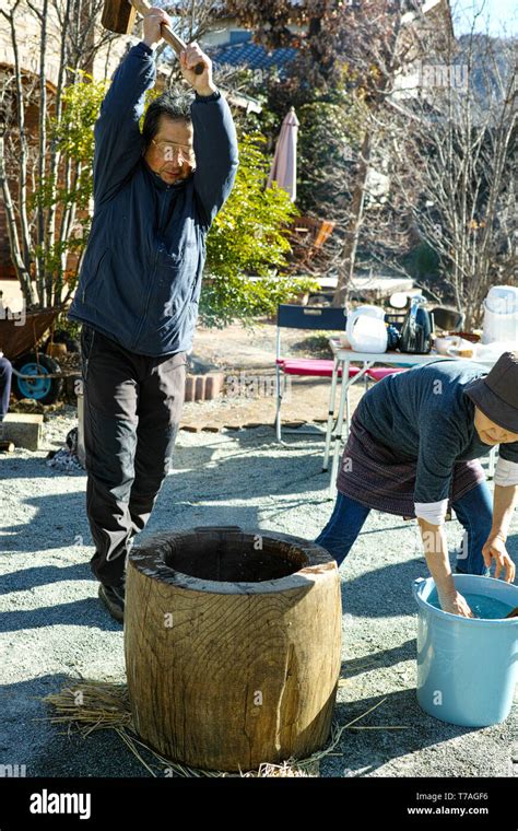 An Elderly Couple Making Mochi In Japan For The New Year Stock Photo