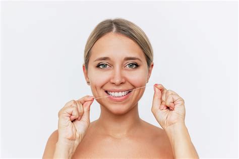 Premium Photo A Young Woman Smiles And Holds A String Between Her