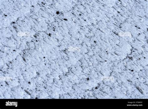 Close Up Photo Of A Textured Ice Surface Speckled With Embedded Debris And Subtle Patterns Stock
