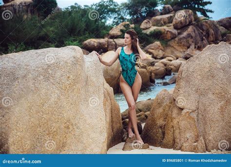 Beautiful Young Brunette Woman In Blue Bikini Posing On The Beach