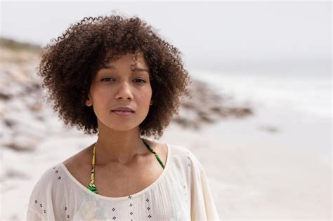 Premium Photo Woman Standing At Beach On A Sunny Day