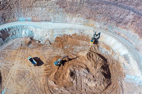 Open Pit Mine In Full Operation With Machinery Extracting Minerals