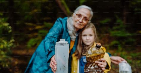 할머니와 함께 숲에서 외딴 곳에서 플라스틱 쓰레기를 보여주는 작은 소녀 사진 Unsplash의 자연 이미지