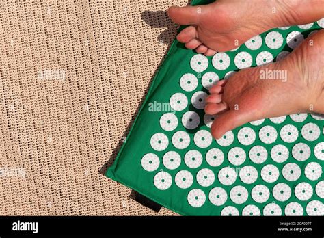Female Feet Standing On Acupressure Mat Self Acupuncture Massage Home Massage Acupuncture