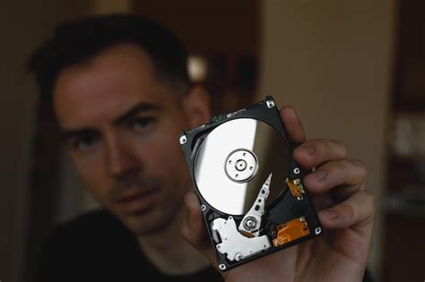 Premium Photo A Man Holding An Hdd Disk In His Hand