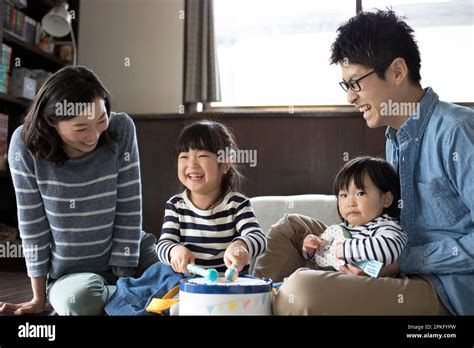 Sisters Playing With A Handmade Musical Instrument Toy And Their