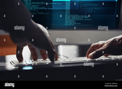Cracking Through A Network Is Every Hackers Craft An Unrecognisable Hacker Using A Computer In