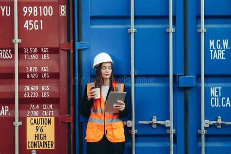 Female Engineer With Clip Folder In White Helmet And Vest Working In Container Terminal Port Or