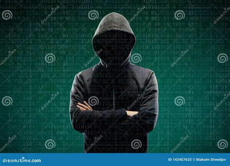 Computer Hacker In Mask And Hoodie Over Abstract Binary Background