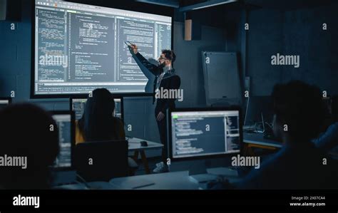 Teacher Giving Computer Science Lecture To Diverse Multiethnic Group Of