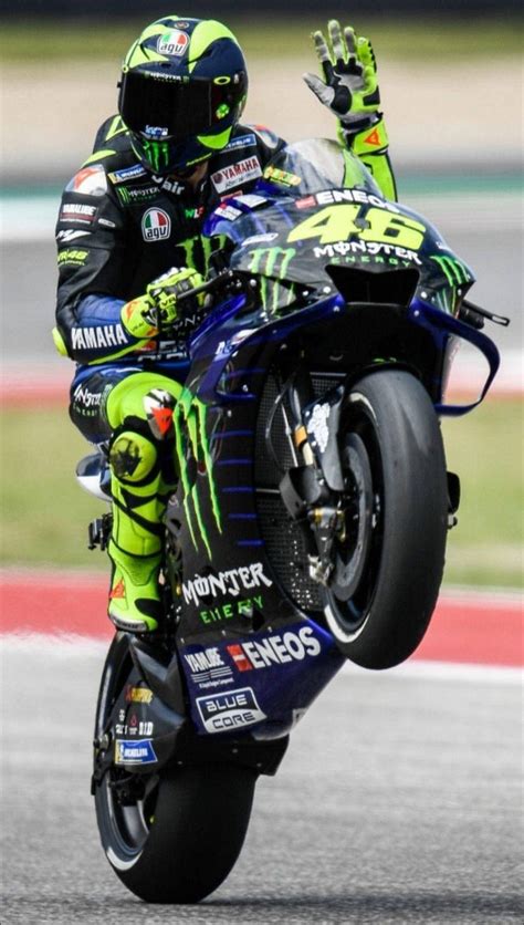Download Valentino Rossi Perfecting A Signature Wheelie Stunt Wallpaper