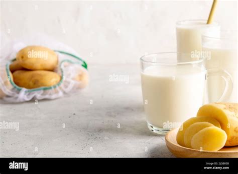 Vegetable Vegan Potato Milk In Glasses And Potato Tubers On Concrete