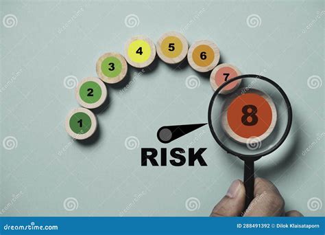 Hand Holding Magnifier Glass With Risk Level Indicator Rating Print Screen Wooden Cube Block