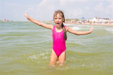 Girl In The Pink Bathing Suit Joyfully Shouts And Gestures By Going