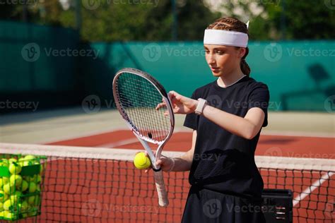 Girl Tennis Player Adjusts The Strings Of A Tennis Racket Close Up During A Match 50485221 Stock