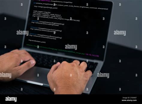 Close Up Of A Programmers Hands Coding On A Laptop Highlights The