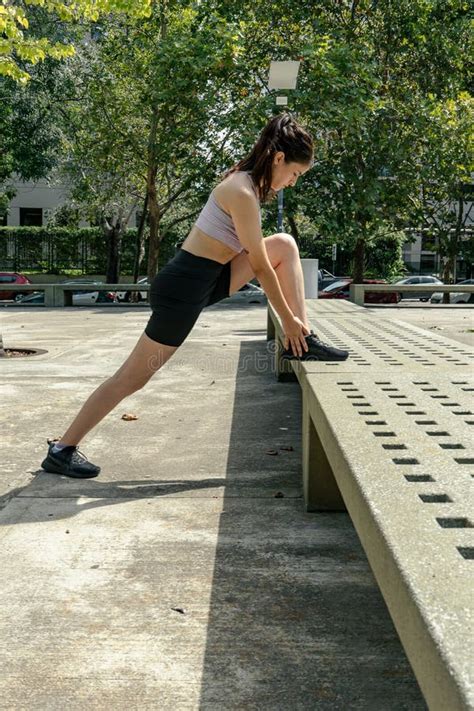 Young Sporty Woman Stretching Legs In A City Park Stock Image Image
